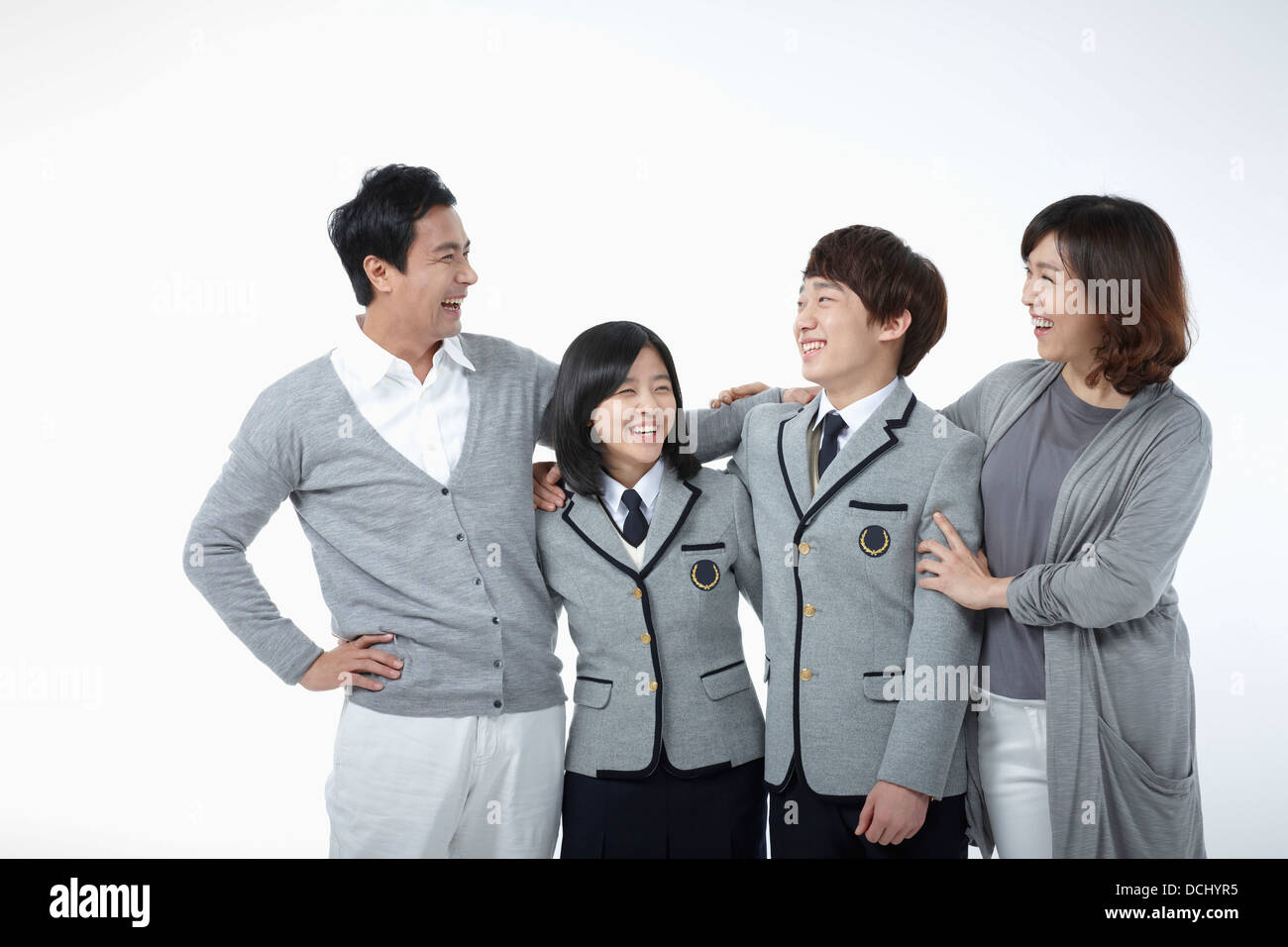 parents next to children with school uniforms Stock Photo - Alamy