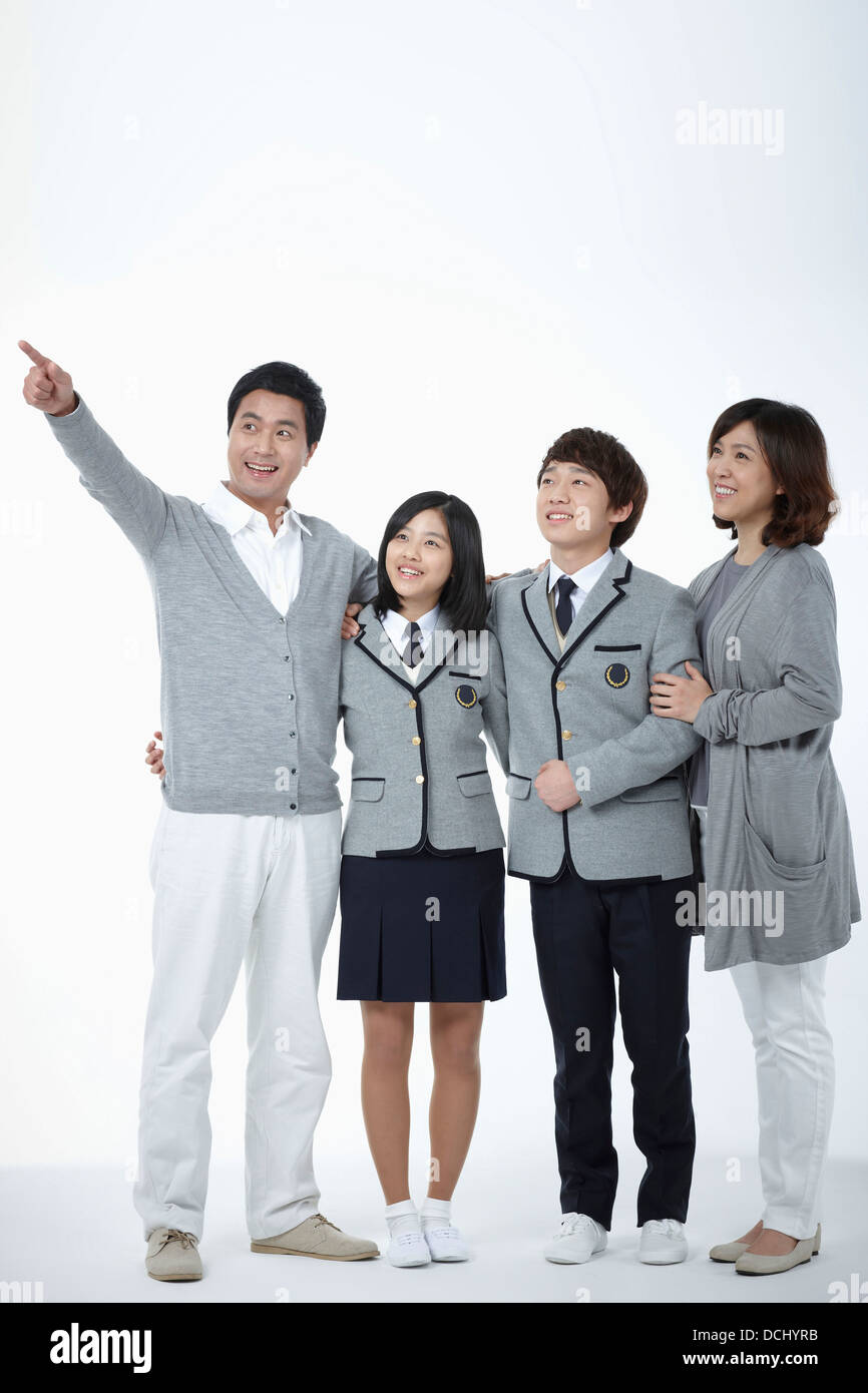parents next to children with school uniforms Stock Photo - Alamy