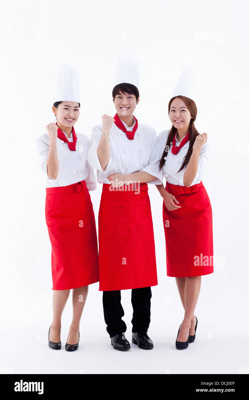 three cook with chef hats posing cheerfully Stock Photo - Alamy