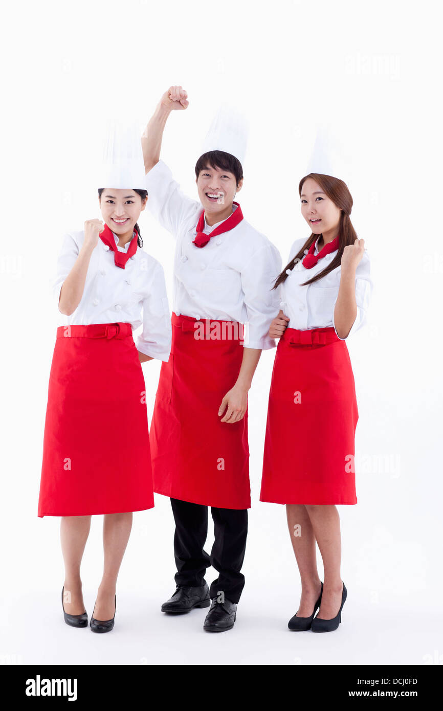 three cook with chef hats posing cheerfully Stock Photo - Alamy