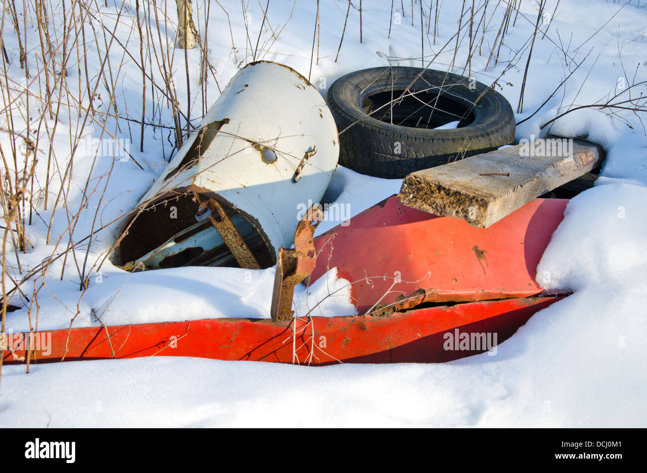 metal and rubber pollution on winter snow. Rubbish in nature Stock ...