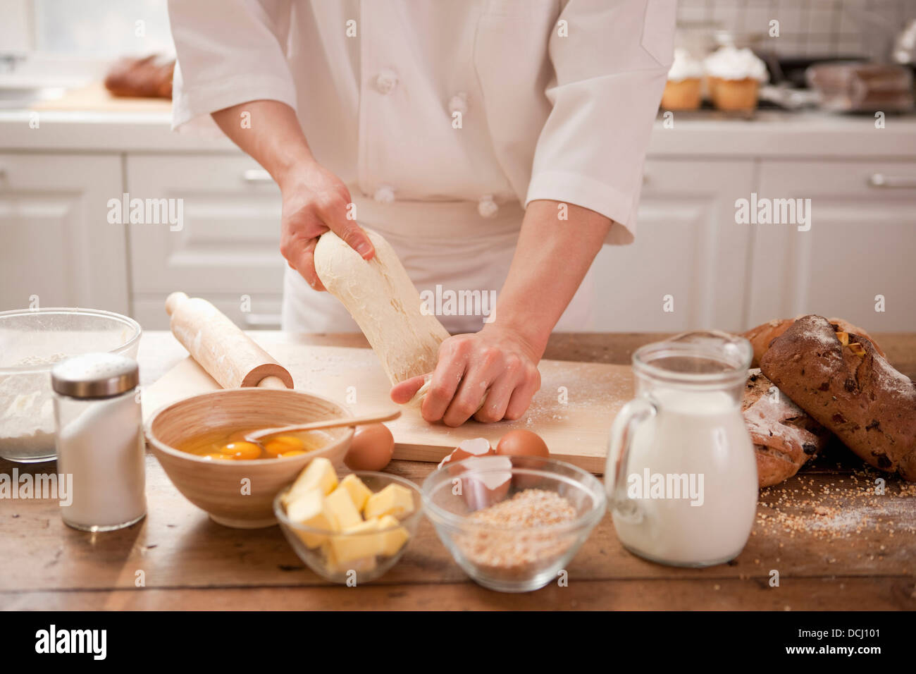 a man making bread with all ingredients on a table Stock Photo - Alamy
