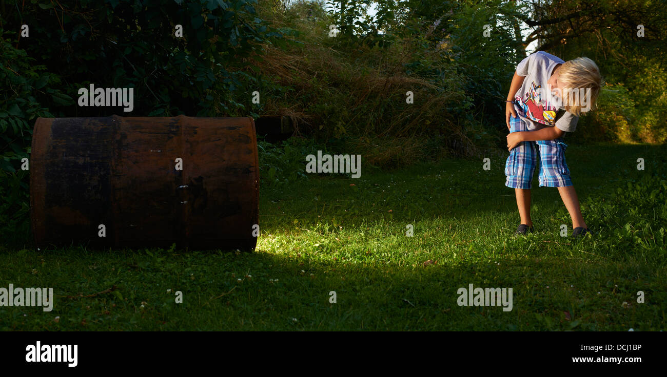 Child boy find a treasure in magic barrel at dusk Stock Photo - Alamy