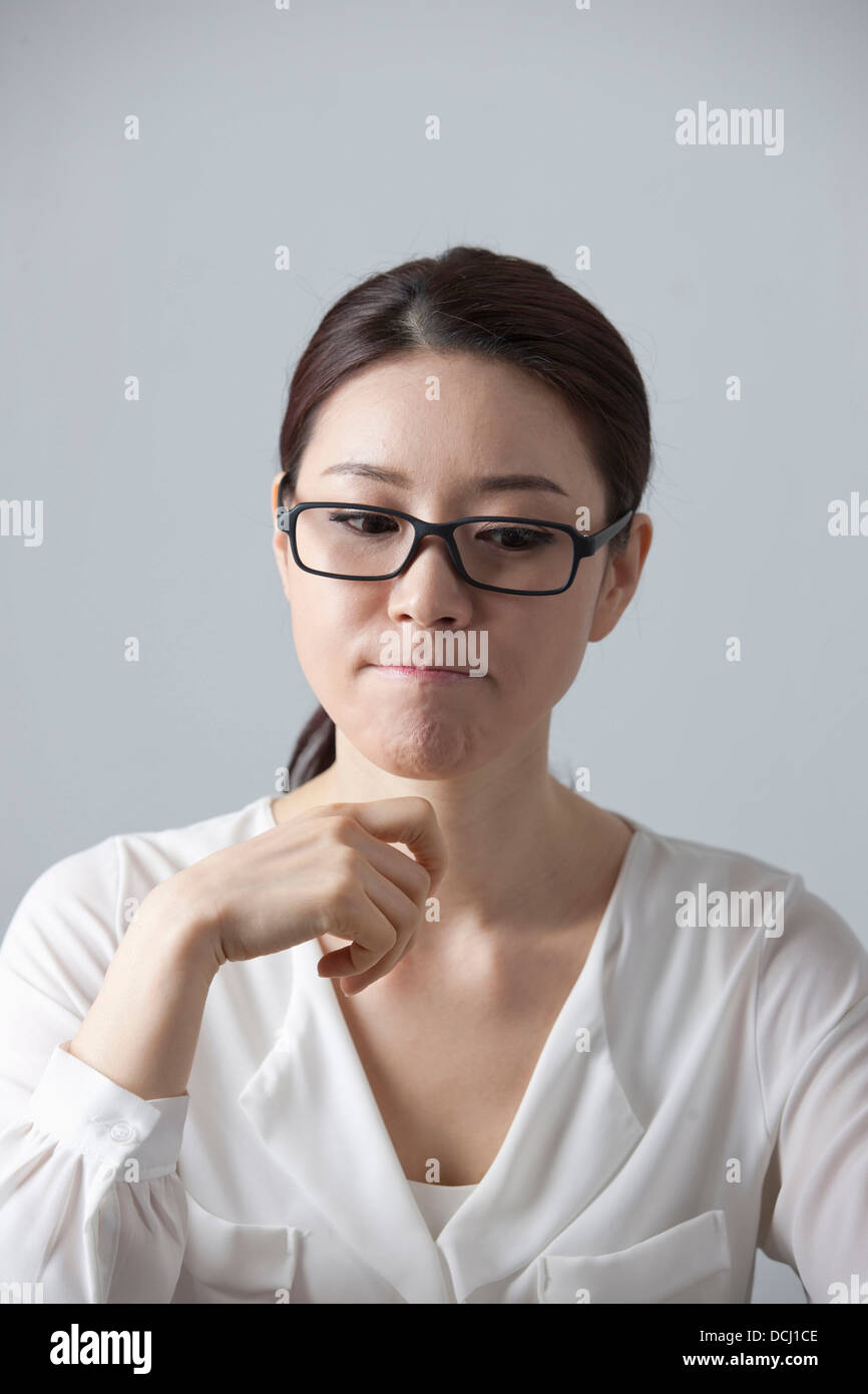 a woman with glasses thinking Stock Photo - Alamy