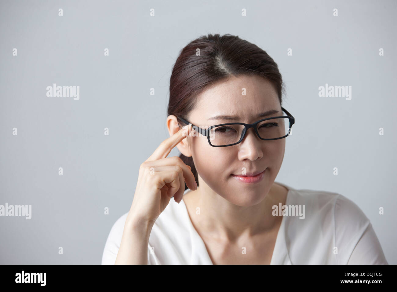 a woman with glasses thinking Stock Photo - Alamy