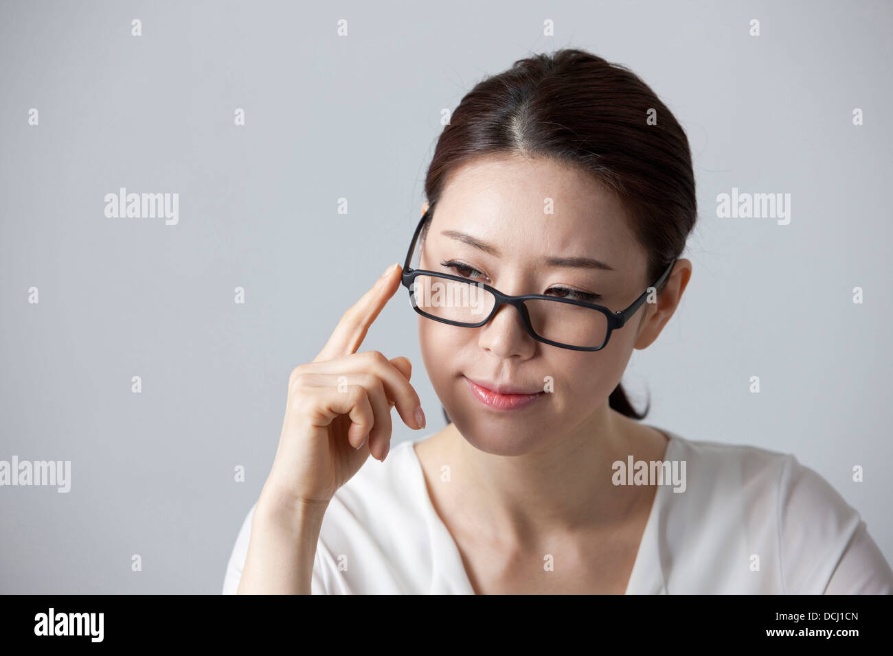 a woman with glasses thinking Stock Photo - Alamy