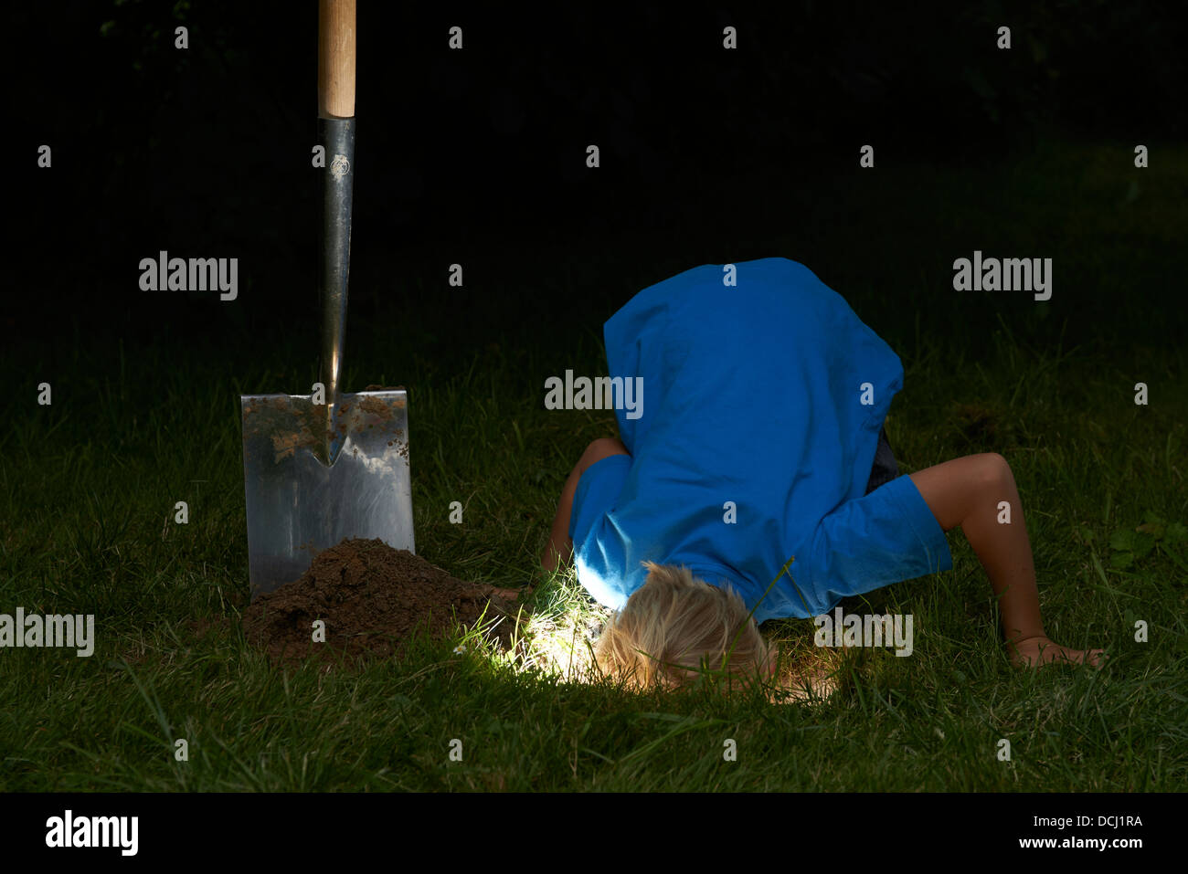 Child boy digging a treasure in magic hole in soil at dusk Stock Photo ...