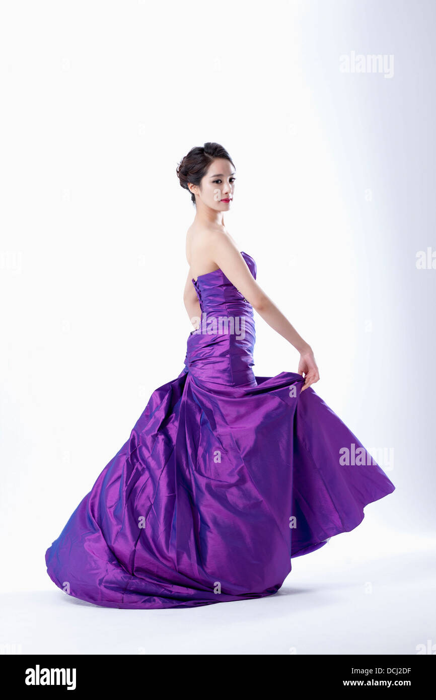 a lady in fancy purple dress posing Stock Photo - Alamy