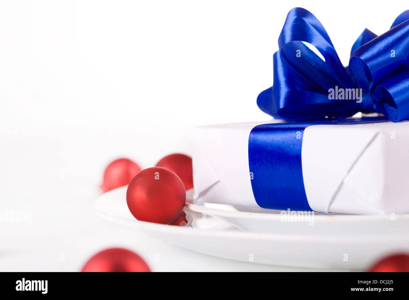 White present with blue ribbons Stock Photo - Alamy