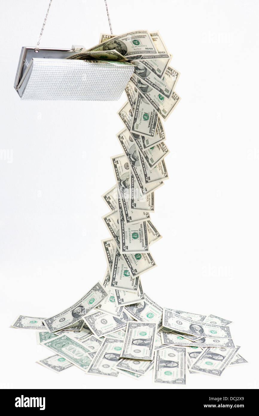 money falling from a purse Stock Photo - Alamy