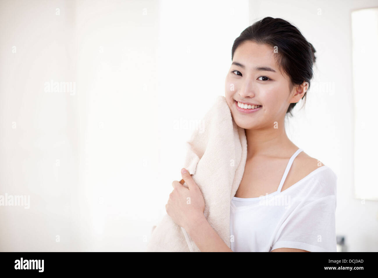 a woman with a towel on her face Stock Photo - Alamy