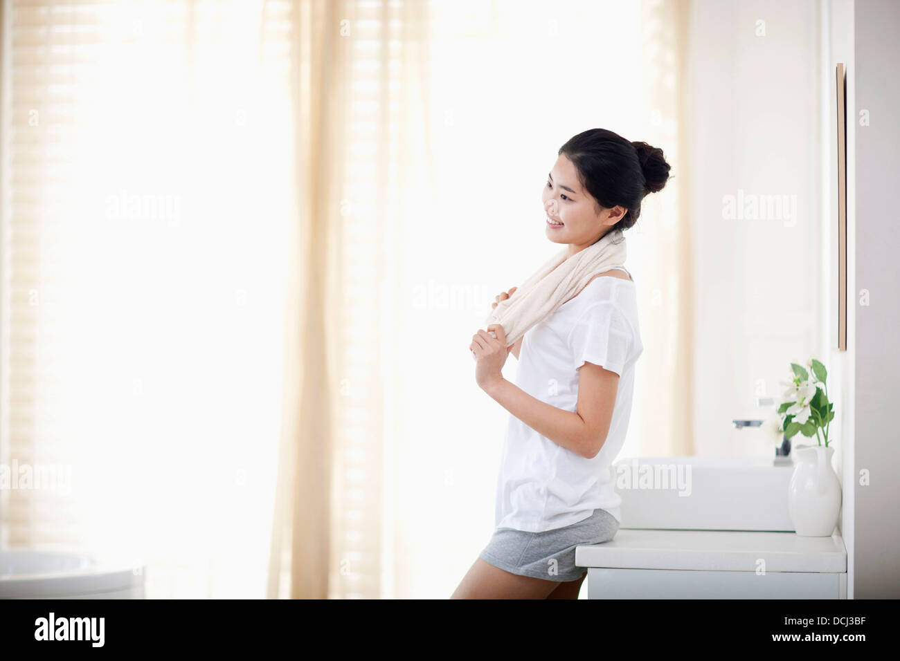 a woman with a towel around the neck Stock Photo - Alamy