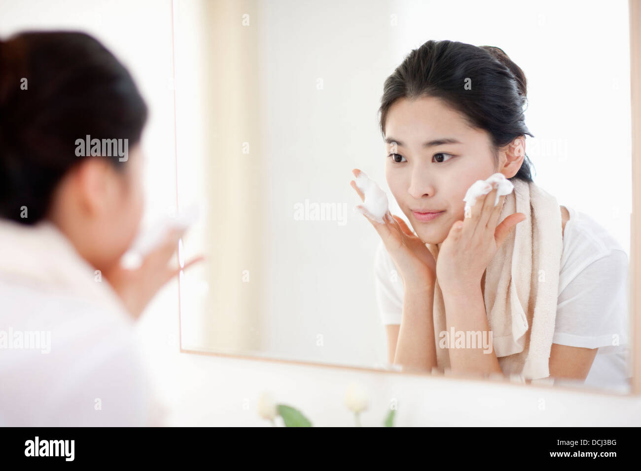 a woman washing her face Stock Photo - Alamy