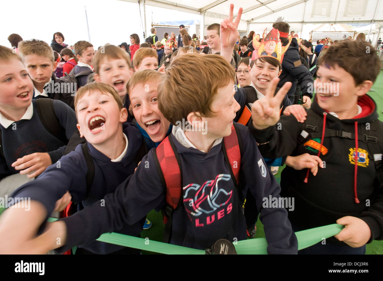 Happy school children queuing for one of the events at the Hay festival ...