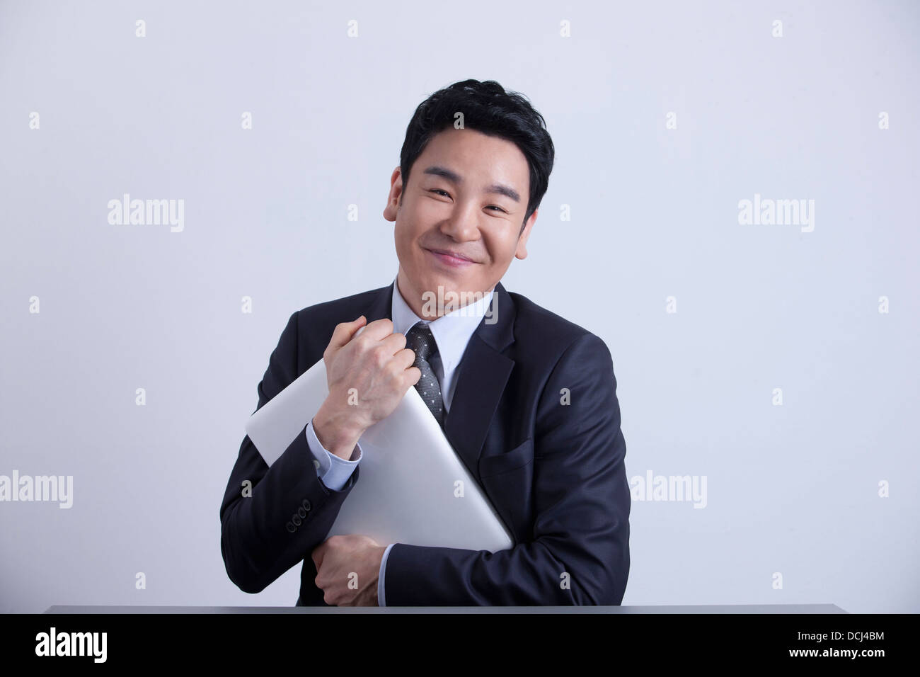 a businessman happily hugging a laptop Stock Photo - Alamy
