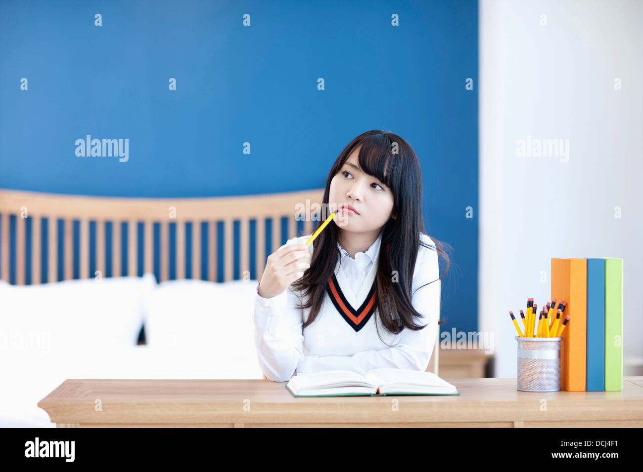 a student sitting at a desk Stock Photo - Alamy
