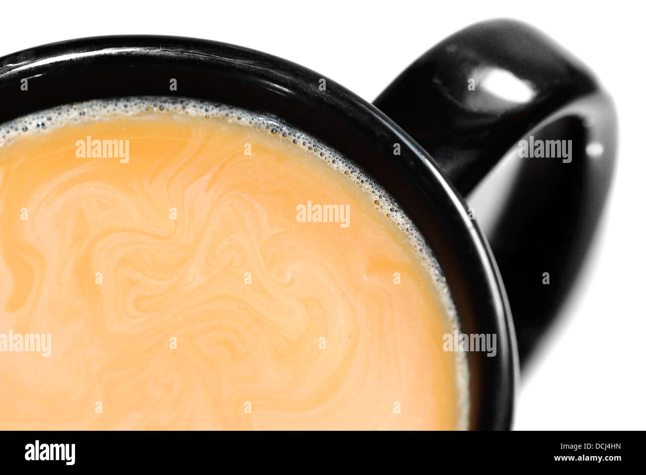 Coffee and cream in black mug Stock Photo - Alamy