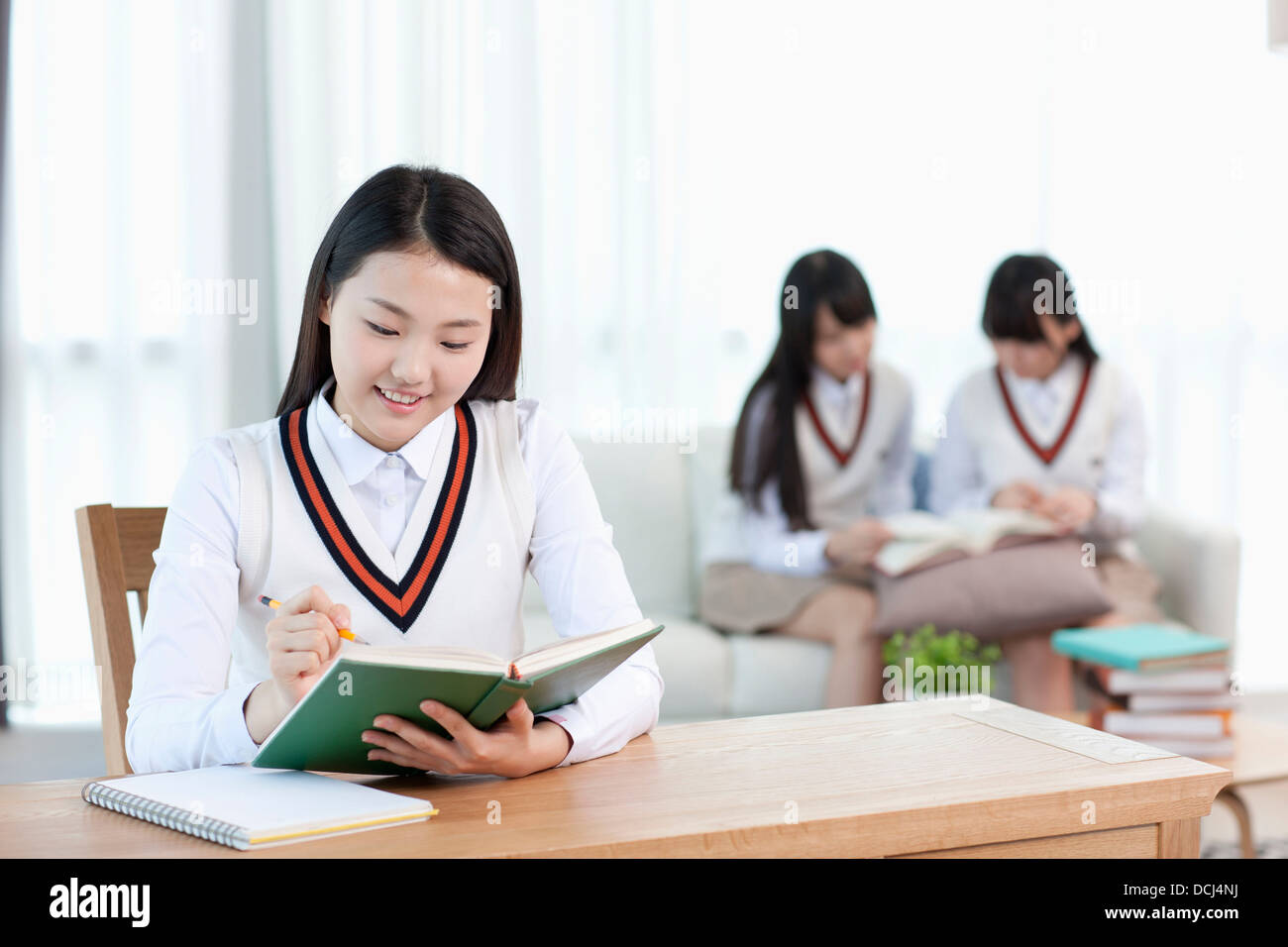 a student sitting at desk studying Stock Photo - Alamy