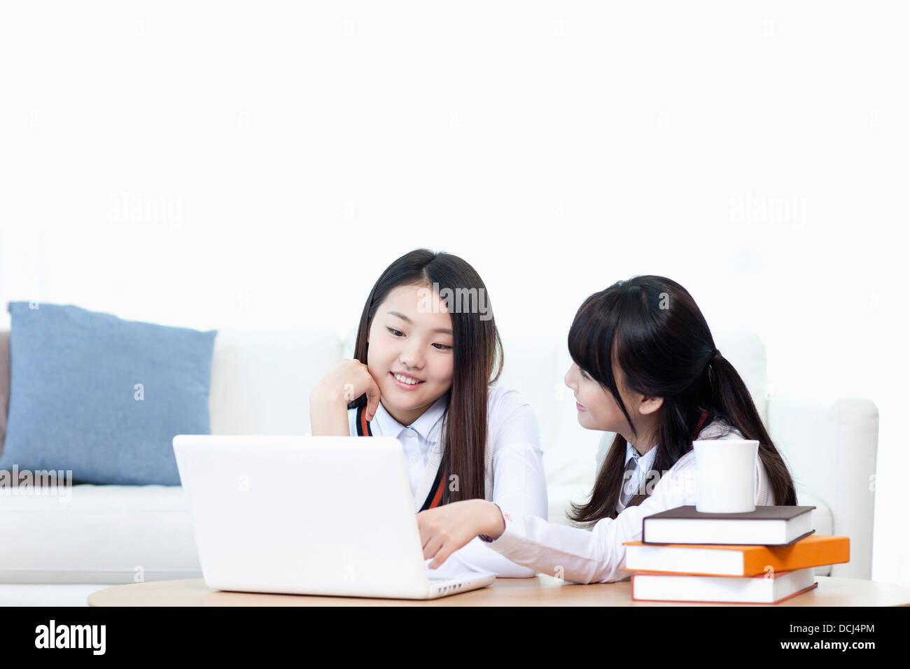 students in uniform using laptop together Stock Photo - Alamy
