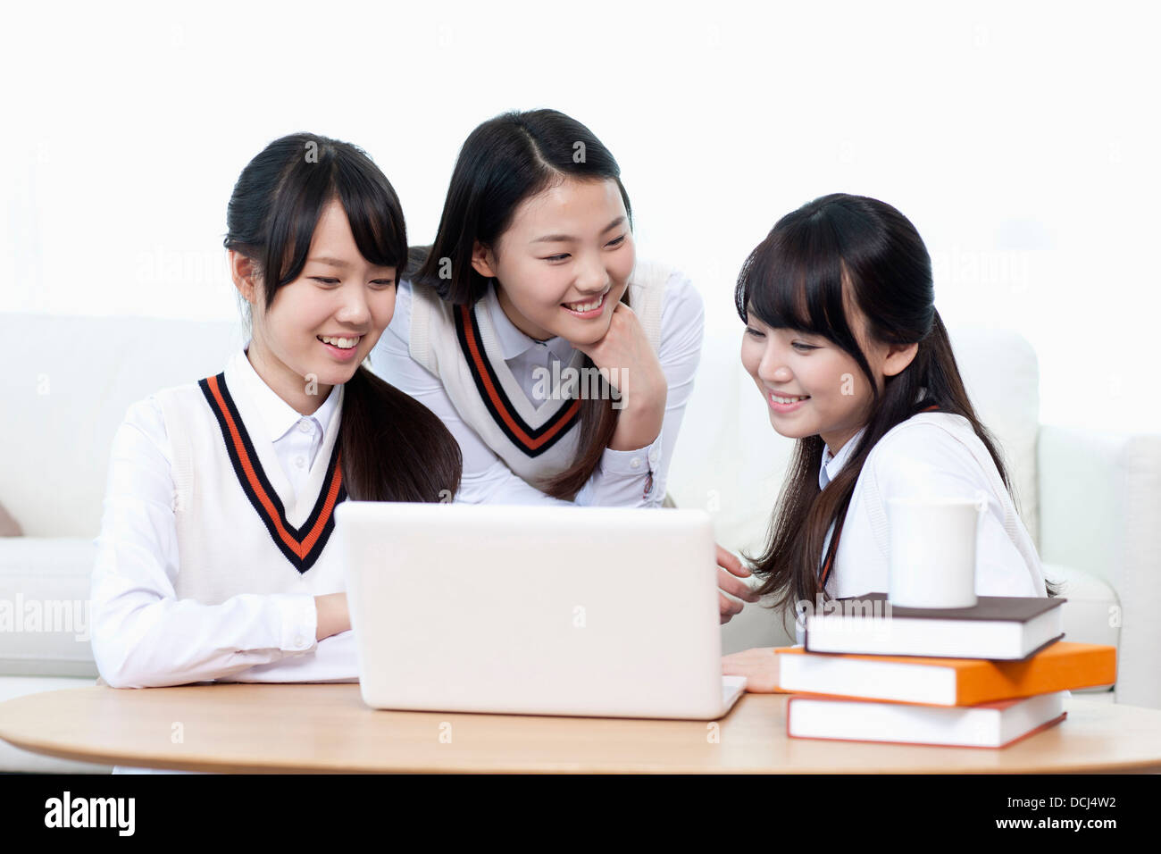students in uniform studying together in a room Stock Photo - Alamy