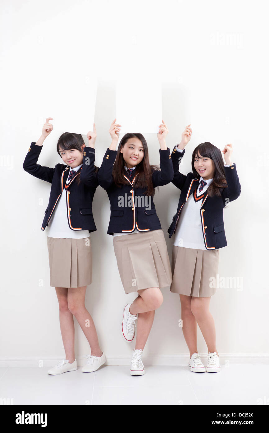 students in uniform posing with white boards Stock Photo - Alamy