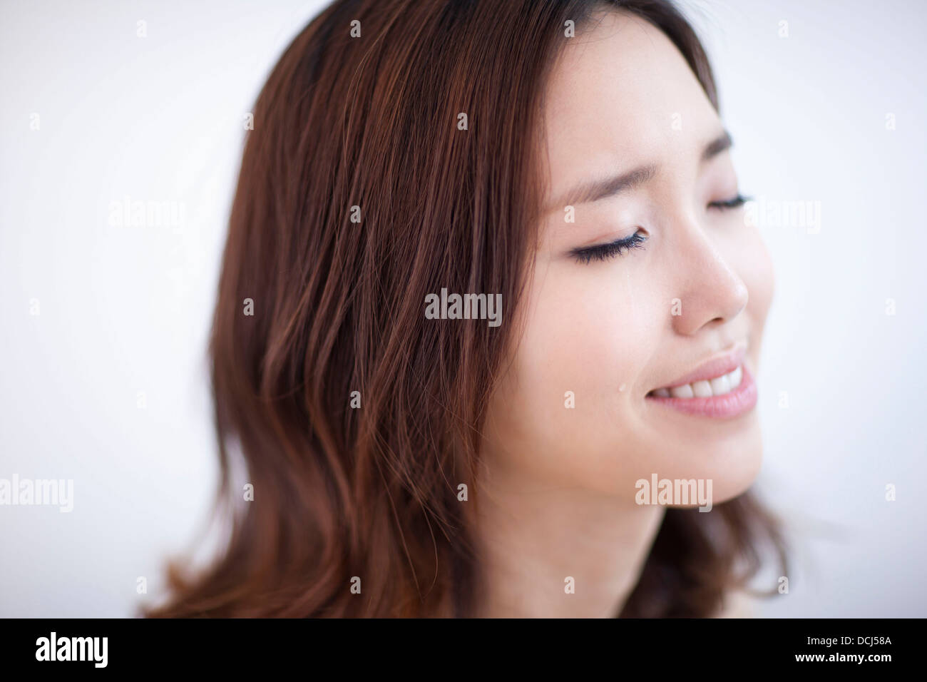 close up shot of a lady smiling while crying Stock Photo - Alamy