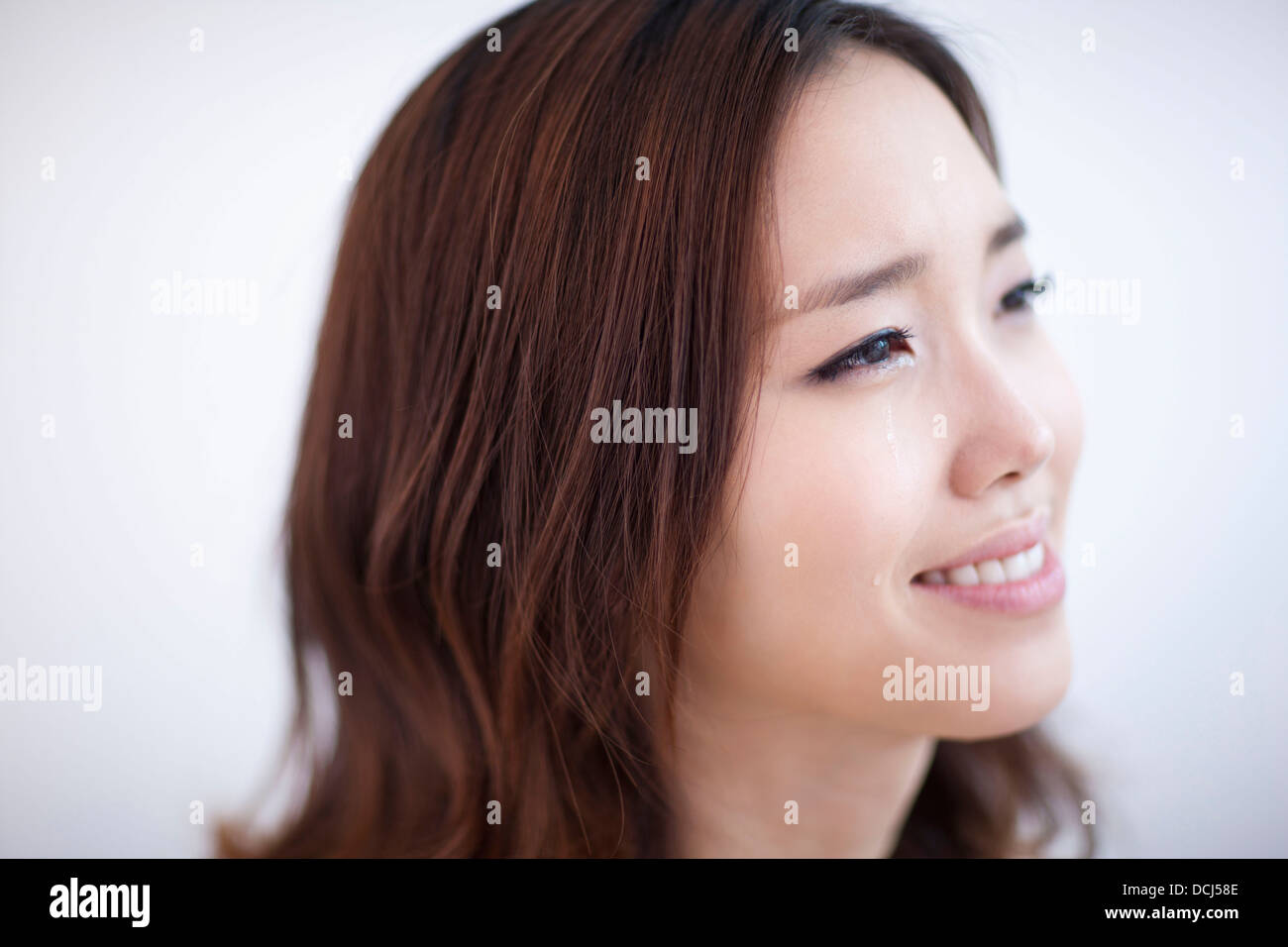 close up shot of a lady smiling while crying Stock Photo - Alamy