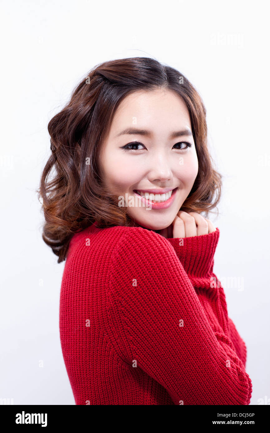 a lady in red sweater smiling Stock Photo - Alamy