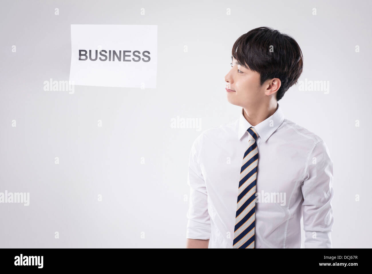 a business man with a paper saying business Stock Photo - Alamy