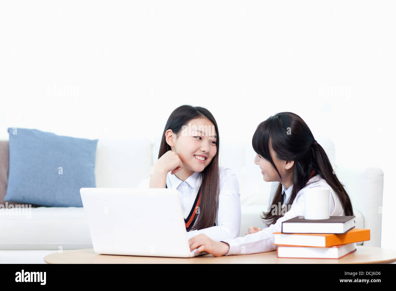 students in uniform using laptop together Stock Photo - Alamy