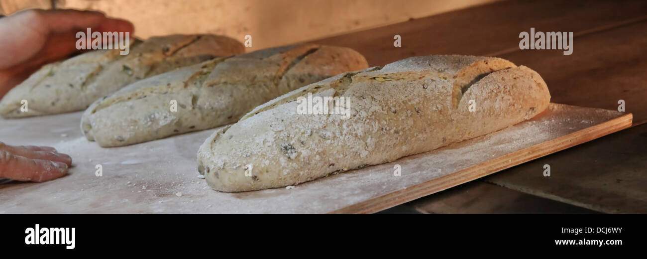 Bread is being put in an oven to bake at a bakery Stock Photo - Alamy