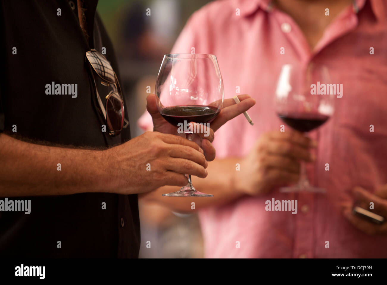 Man holding cigarette wine glass hi-res stock photography and images ...