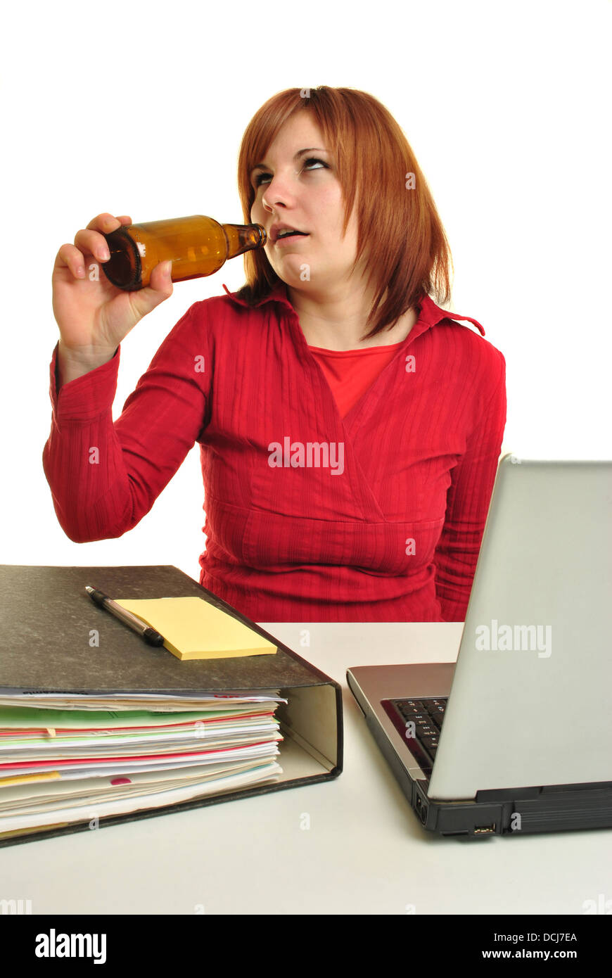 a young woman drinking at her office desk Stock Photo - Alamy