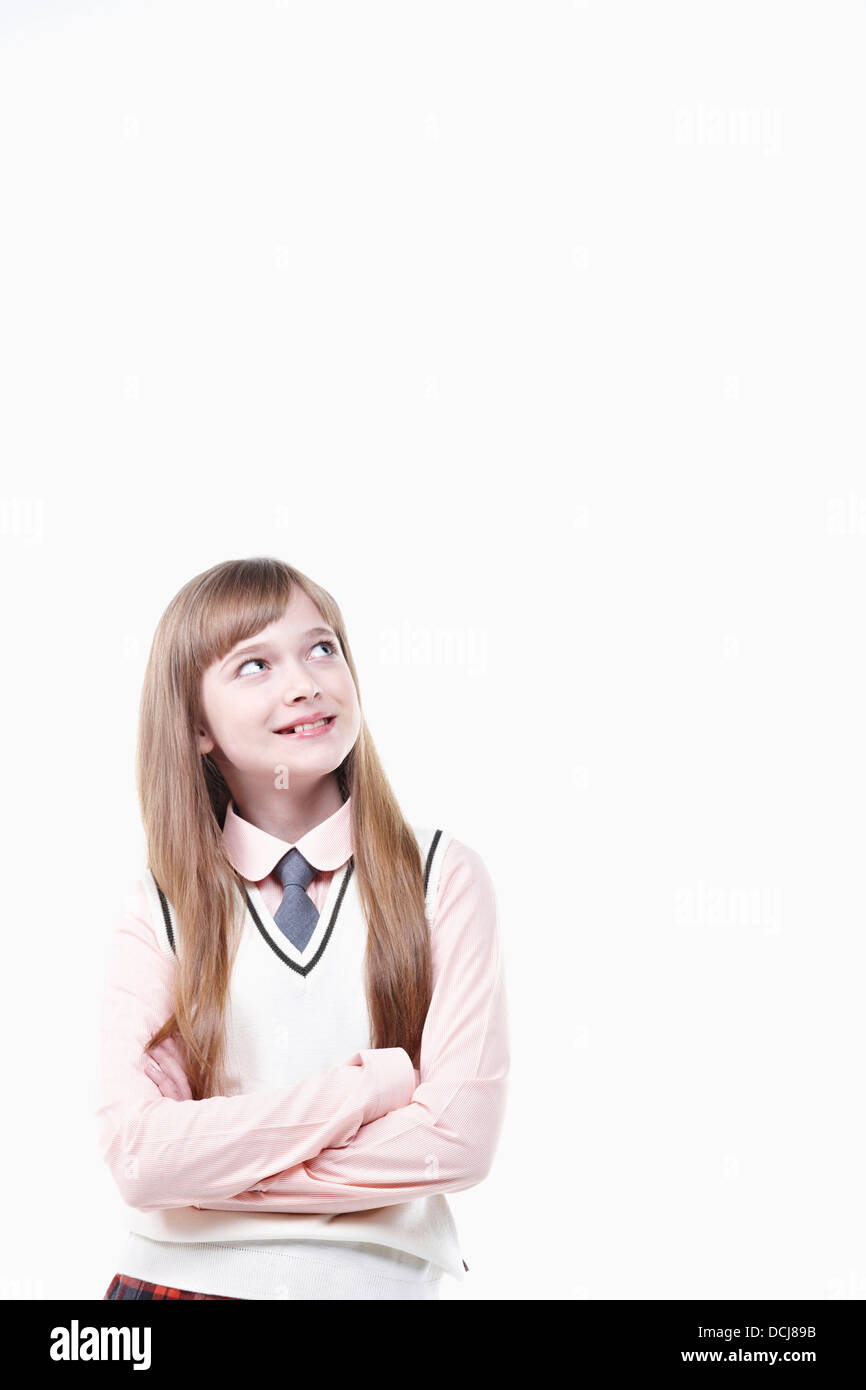 a student in uniform standing arms crossed on white background Stock ...