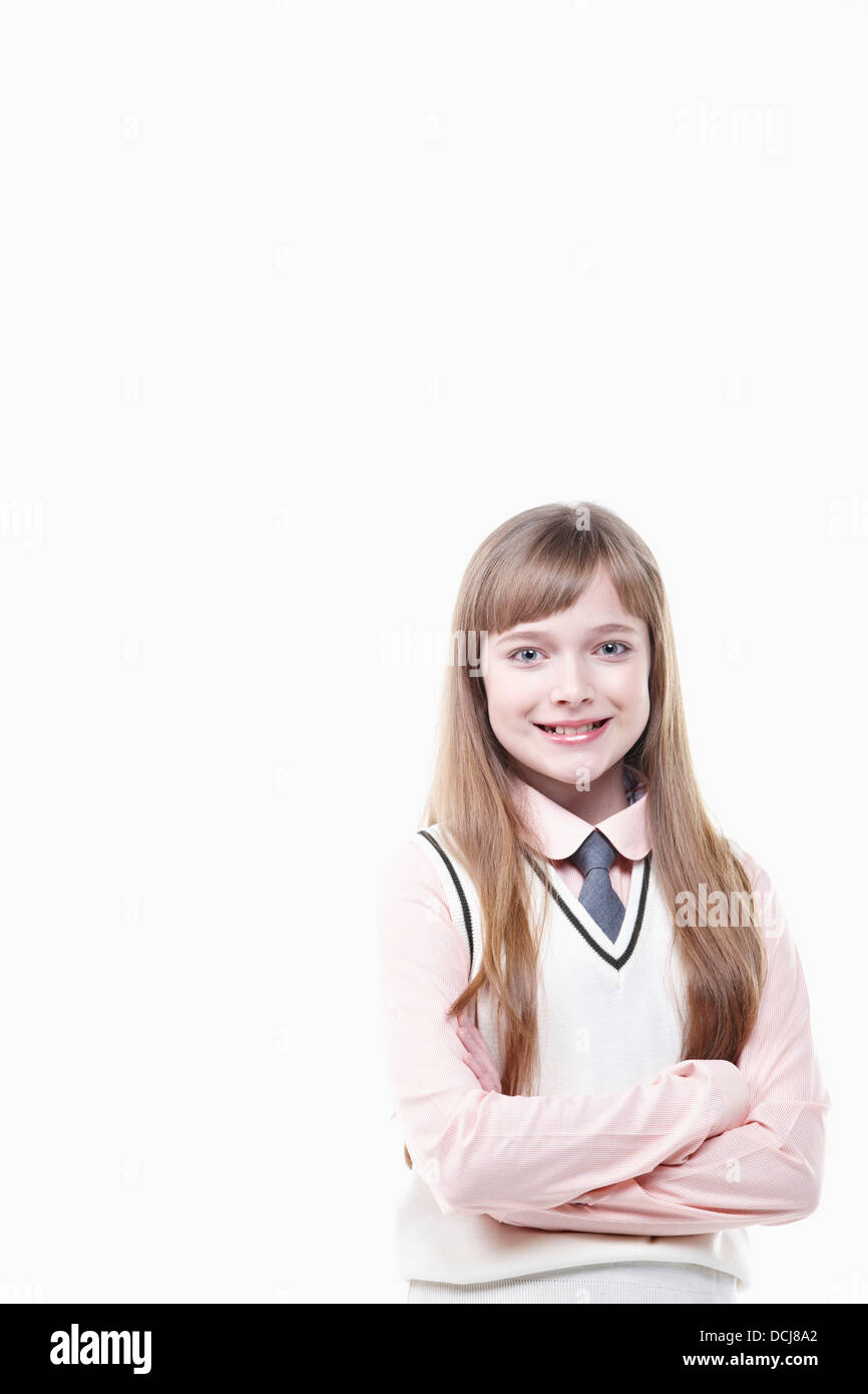 a student in uniform standing arms crossed on white background Stock ...