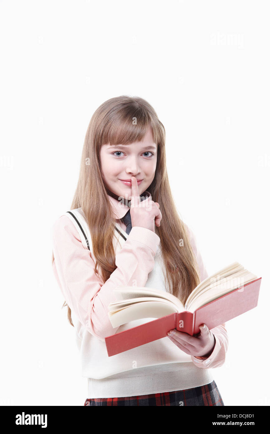 a student in uniform reading a book on white background Stock Photo - Alamy