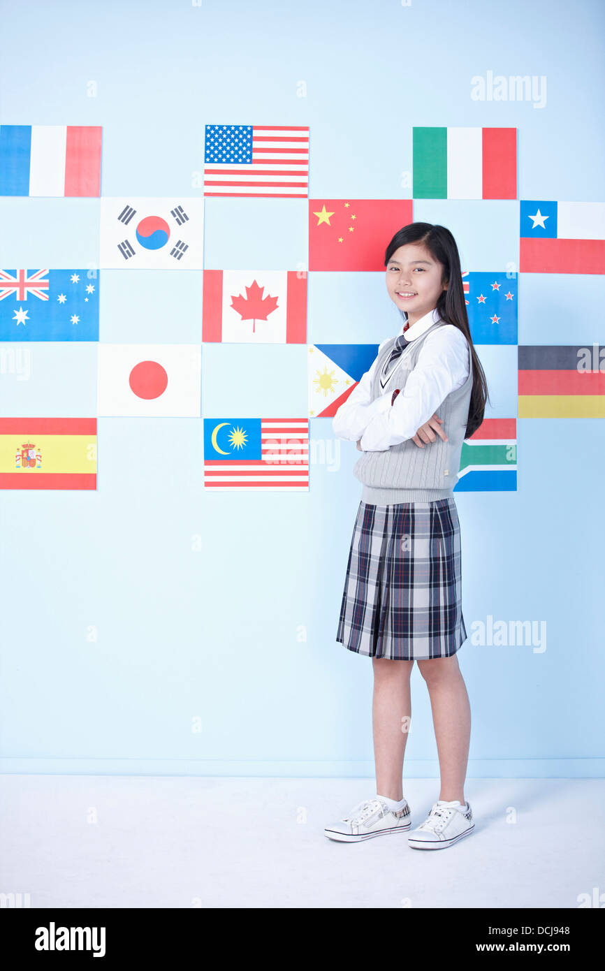 a student in uniform standing in front of international flags Stock ...