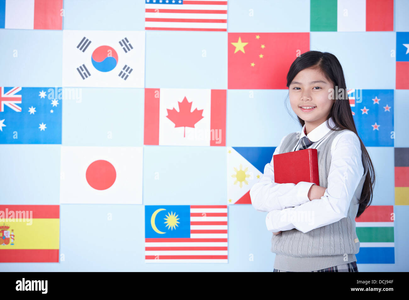 a student in uniform standing in front of international flags Stock ...