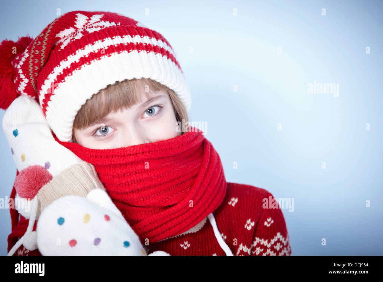 a girl in winter outfit covering face with scarf Stock Photo - Alamy