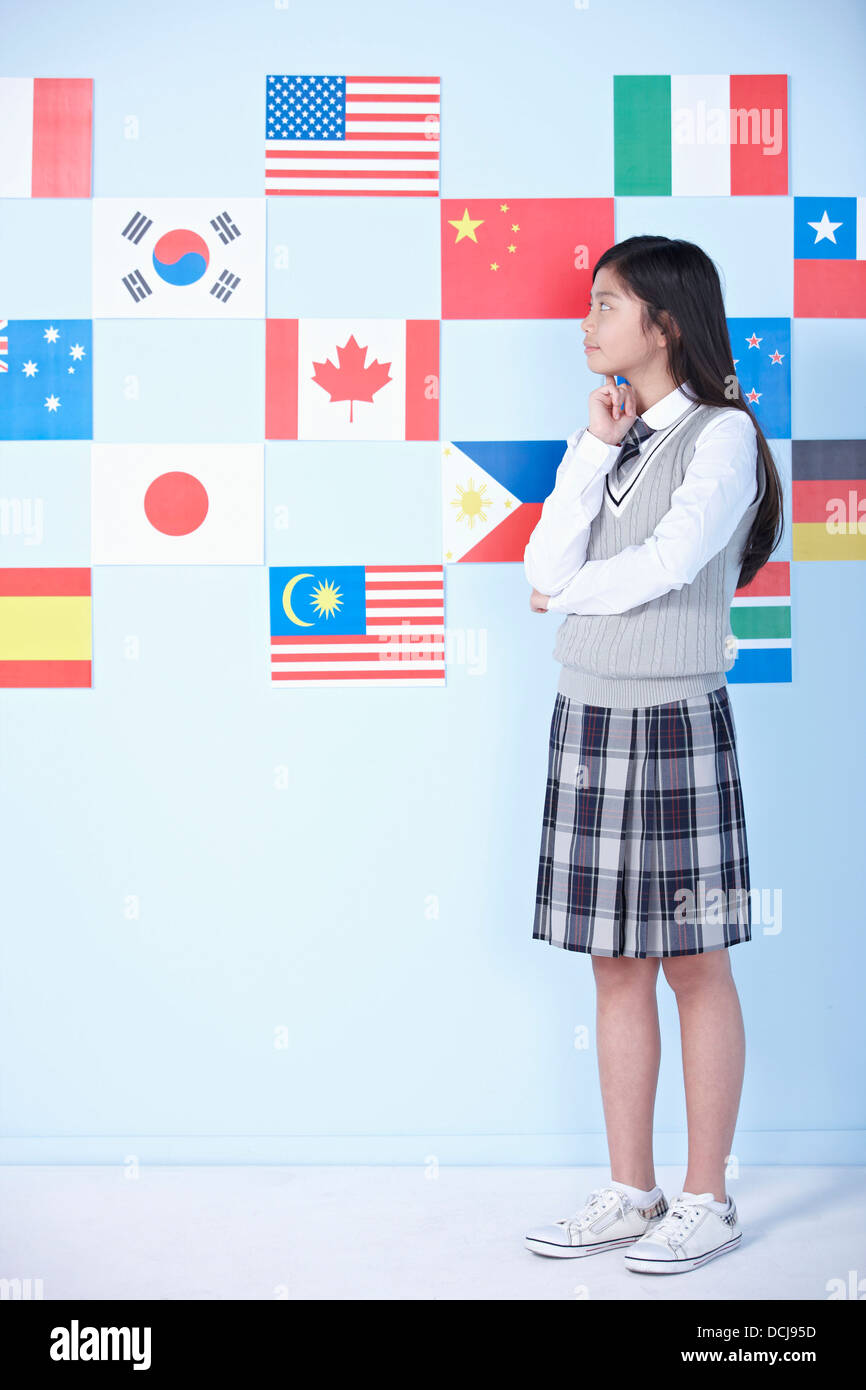 a student in uniform standing in front of international flags Stock ...
