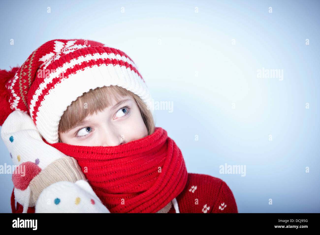a girl in winter outfit covering face with scarf Stock Photo - Alamy