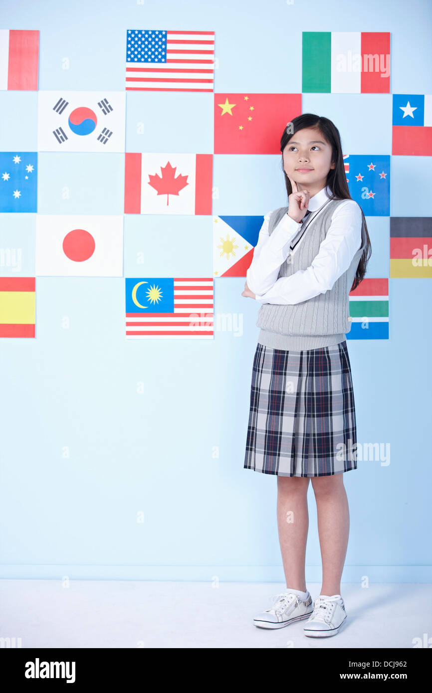 a student in uniform standing in front of international flags Stock ...