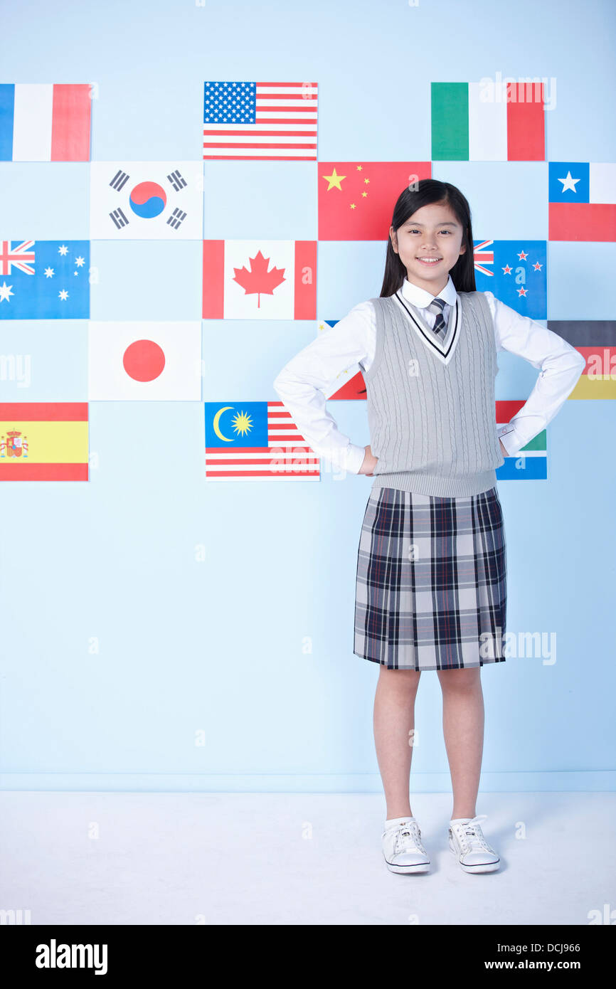 a student in uniform standing in front of international flags Stock ...