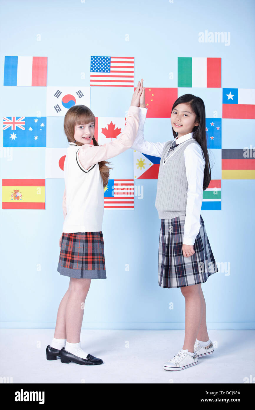 students in uniform standing in front of international flags Stock ...