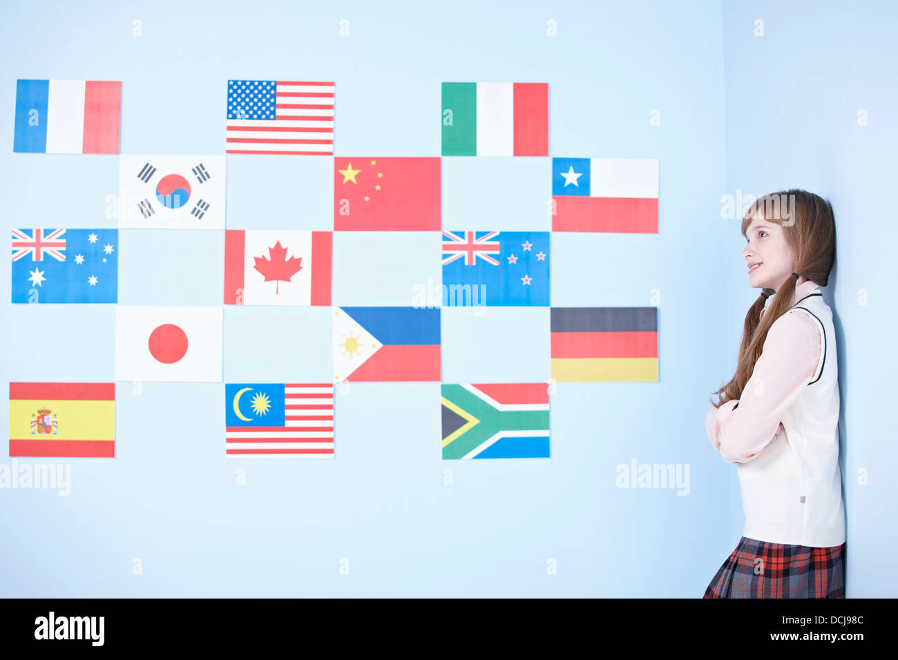 a student in uniform standing next to international flags Stock Photo ...