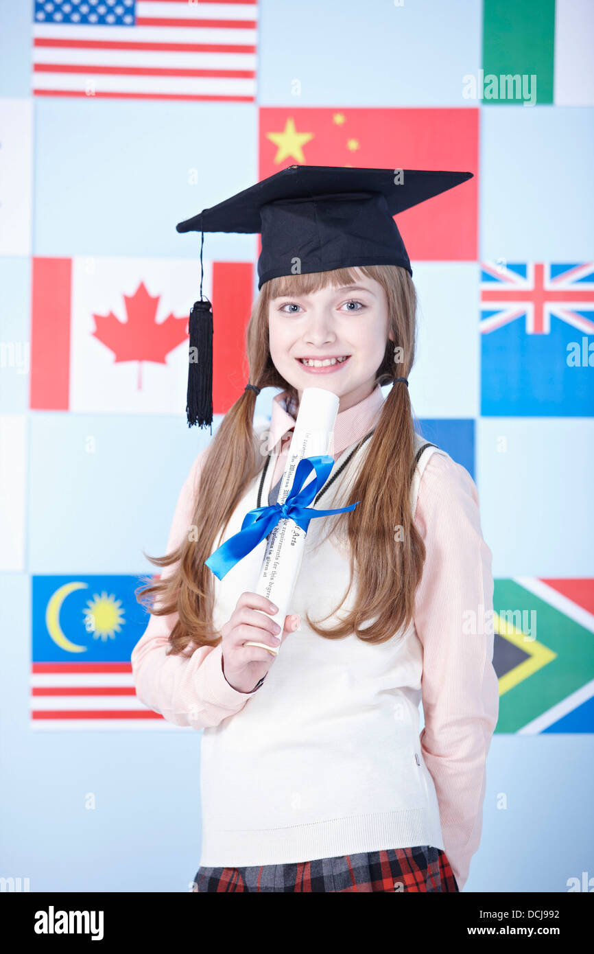 a student in uniform standing in front of international flags with ...