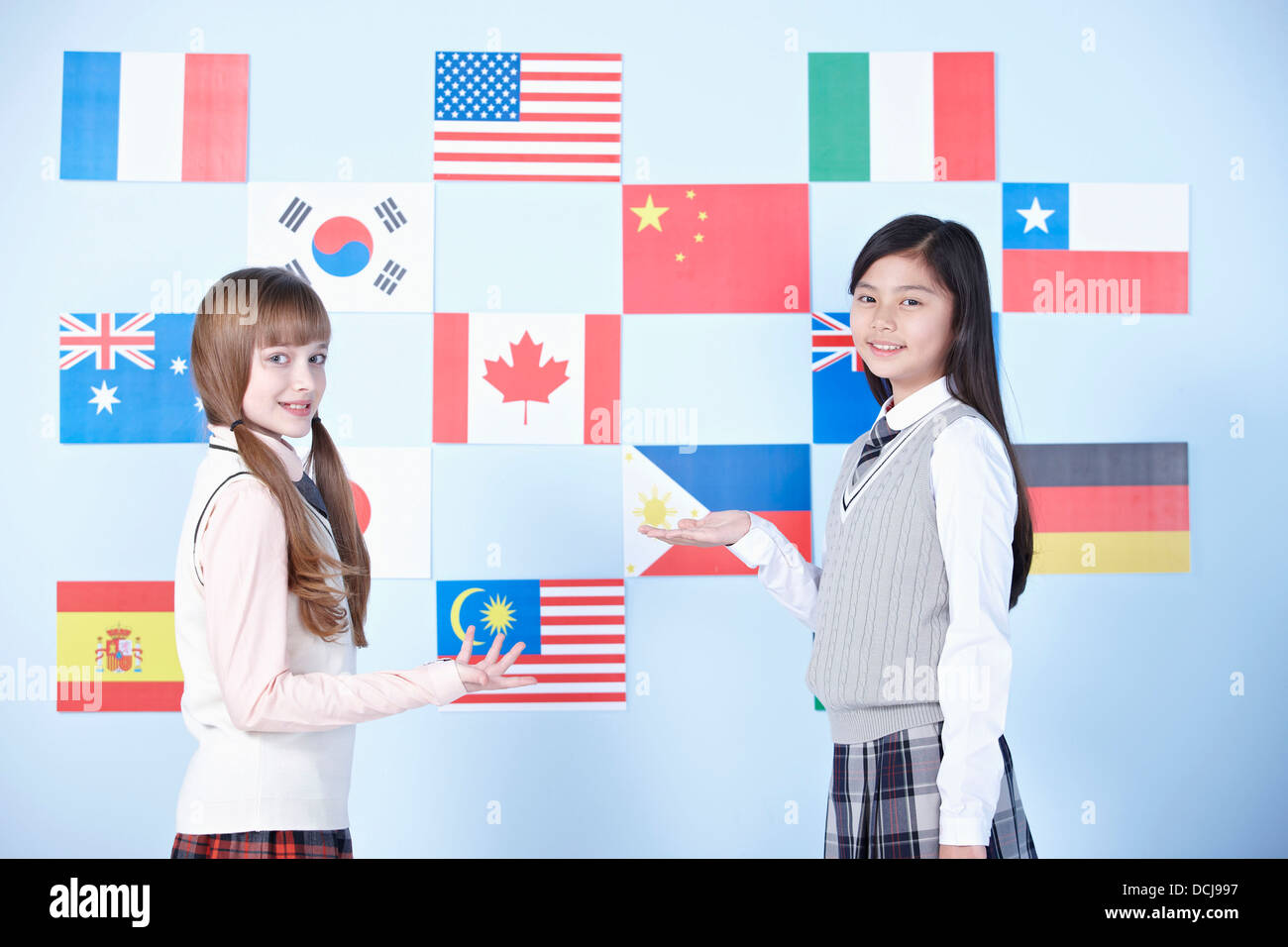 students in uniform standing in front of international flags Stock ...