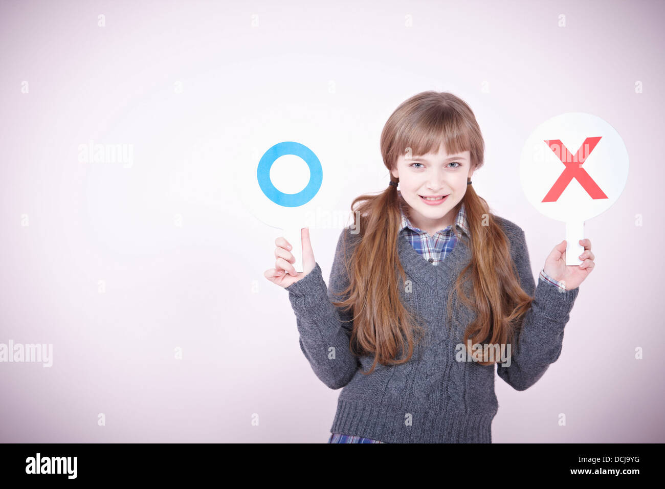 a girl holding boards saying correct and wrong Stock Photo - Alamy