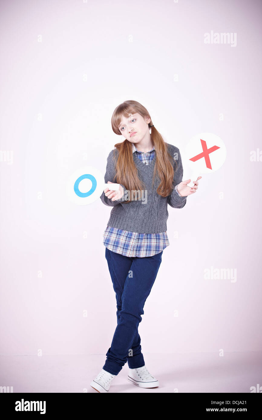 a girl holding boards saying correct and wrong Stock Photo - Alamy
