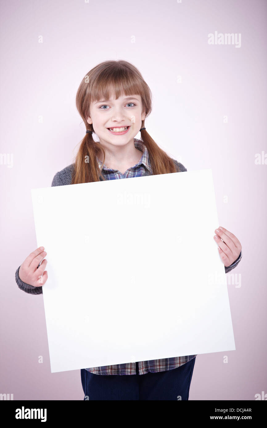 a girl holding a blank piece of paper Stock Photo - Alamy